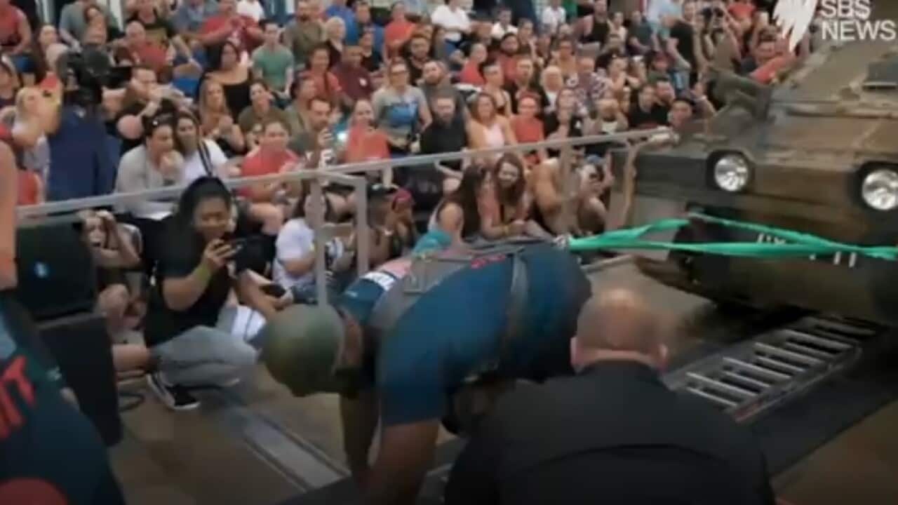 Australia's strongest man holds on again | SBS News