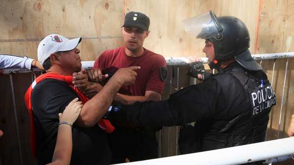 Boca players hit by tear gas as rival fans throw rocks at team bus ...